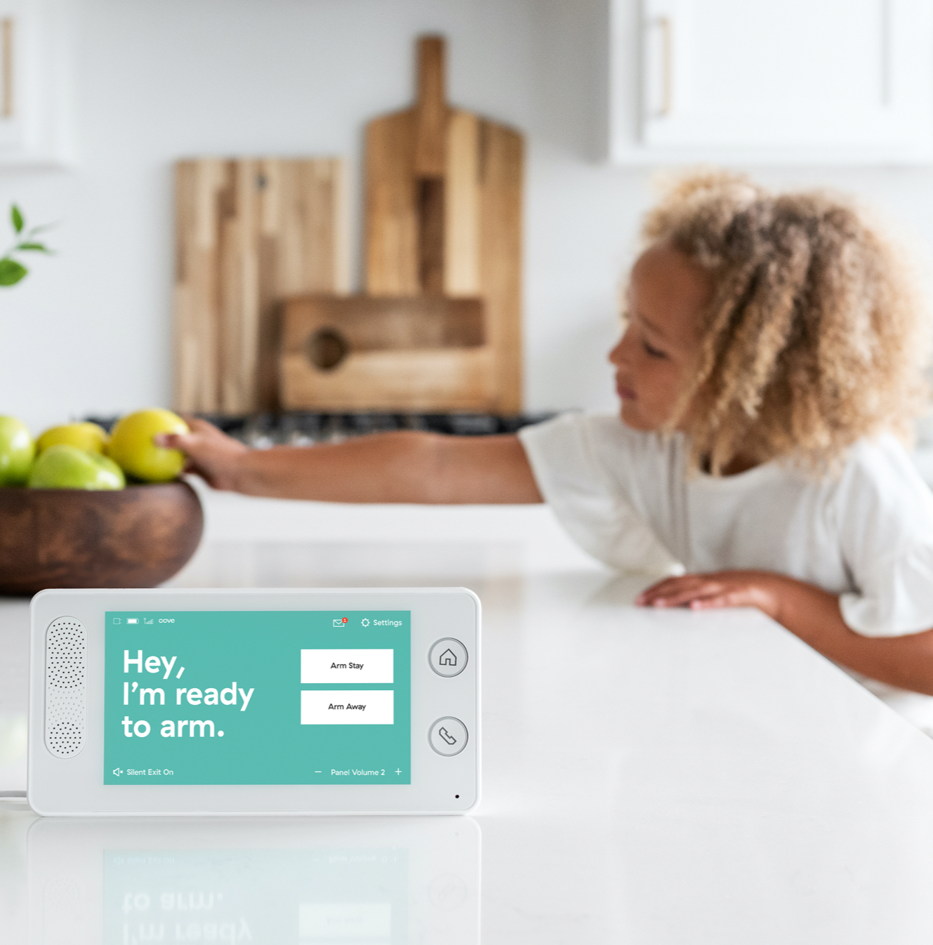 girl in kitchen with security panel